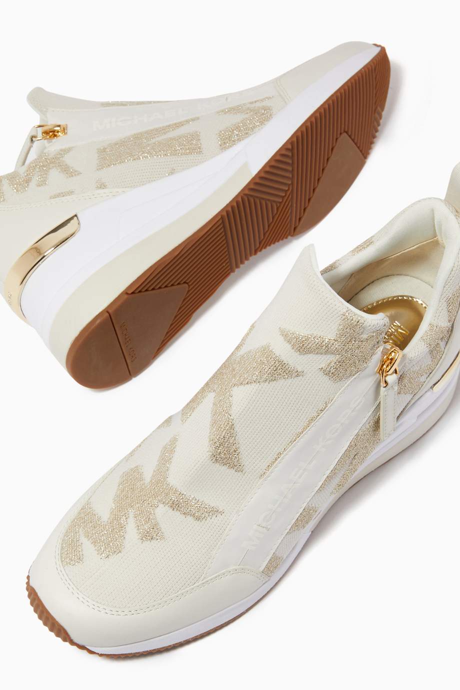 Shop Michael Kors Gold Willis Wedge Sneakers in Stretch Knit for Women ...